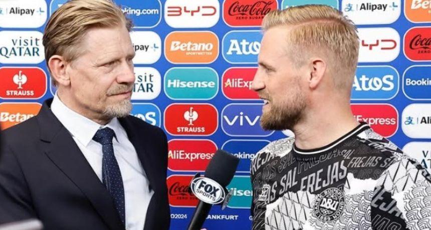 Father-son moment: Peter and Kasper Schmeichel share a hug during live ...