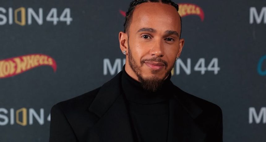 Lewis Hamilton snowboards and leaps from a helicopter during winter ...