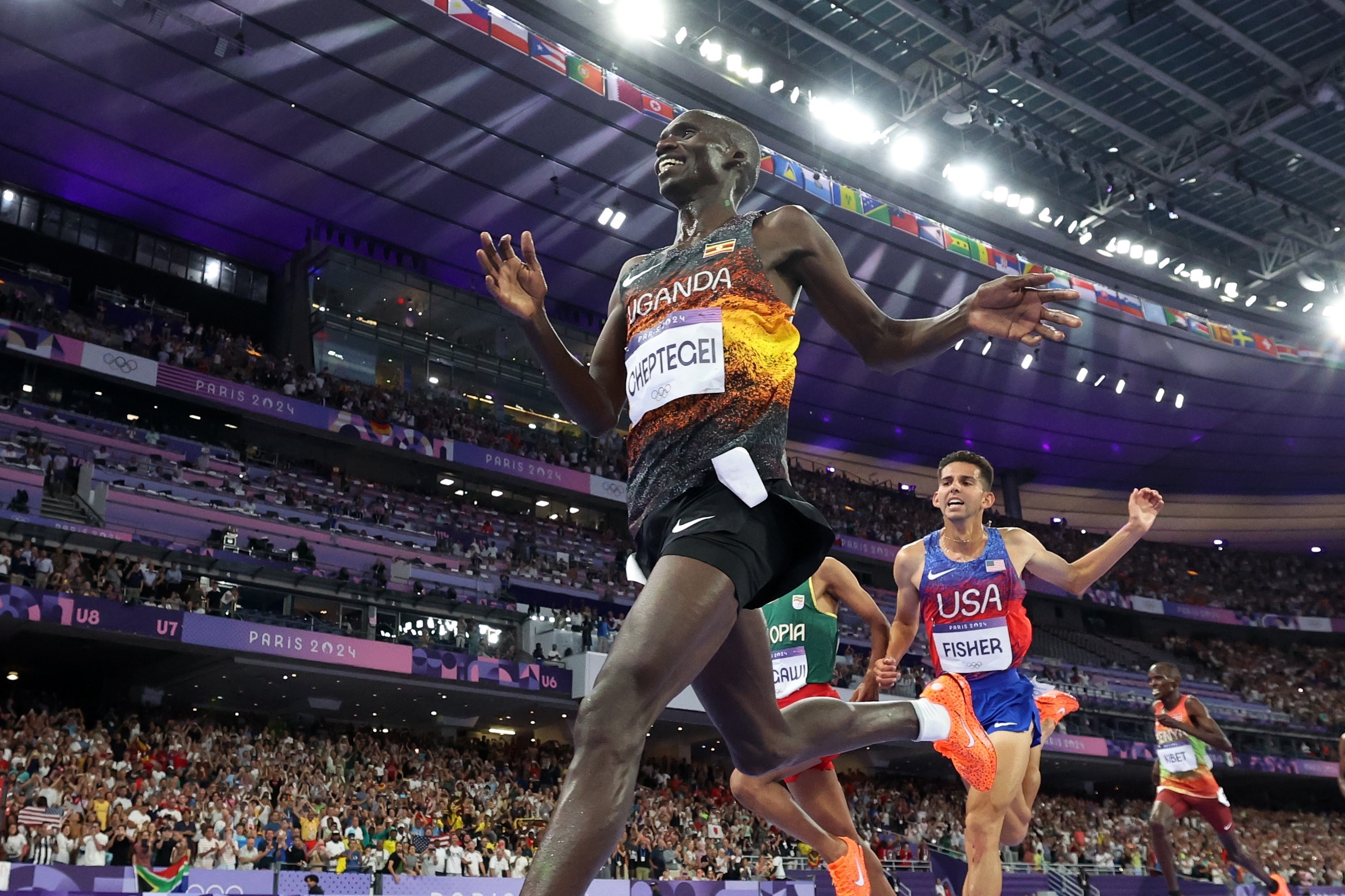 The athlete from Uganda sets an Olympic record in the 10,000 meters ...